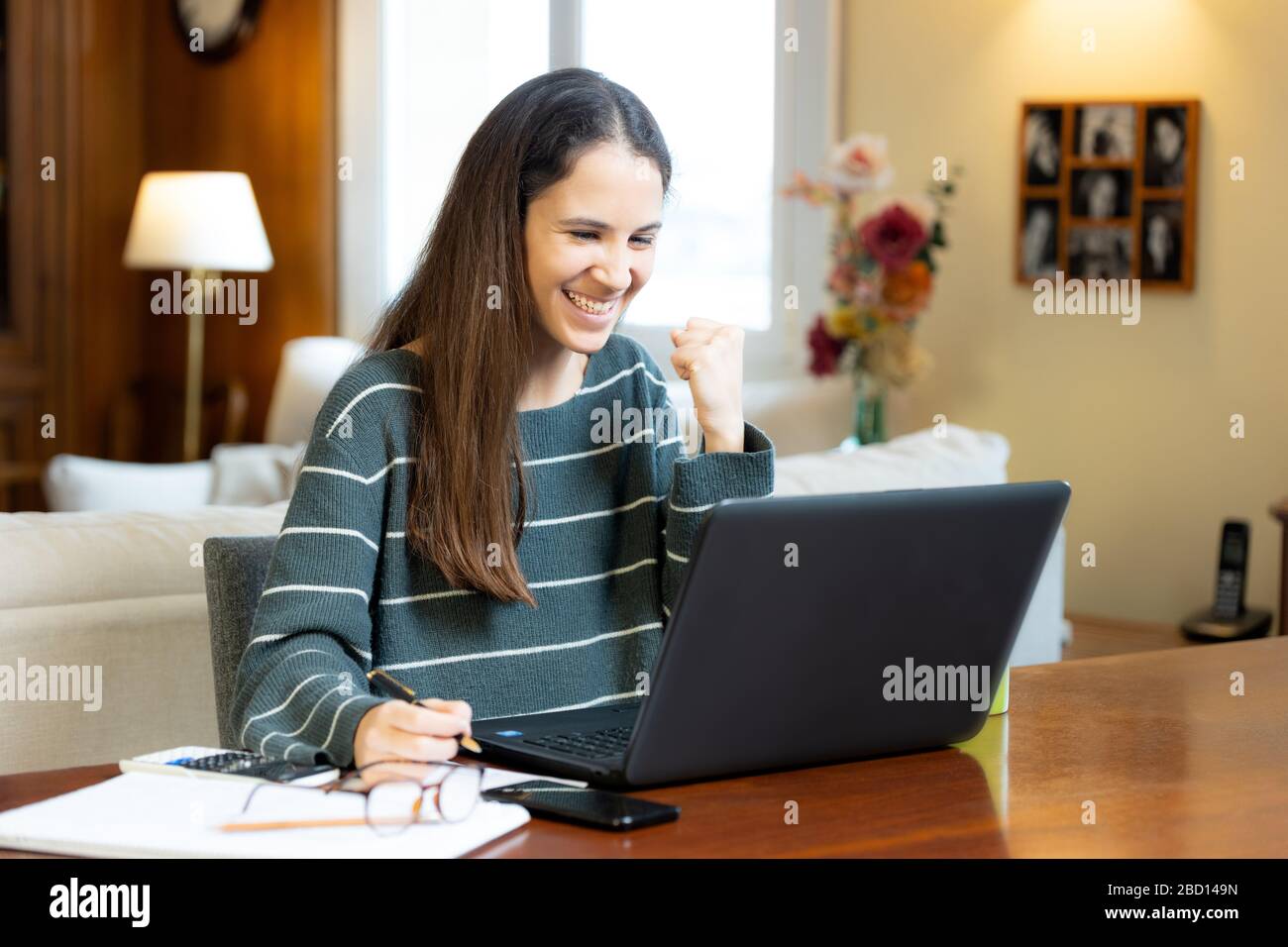 teenage girl studying remotely and taking notes at home Stock Photo - Alamy