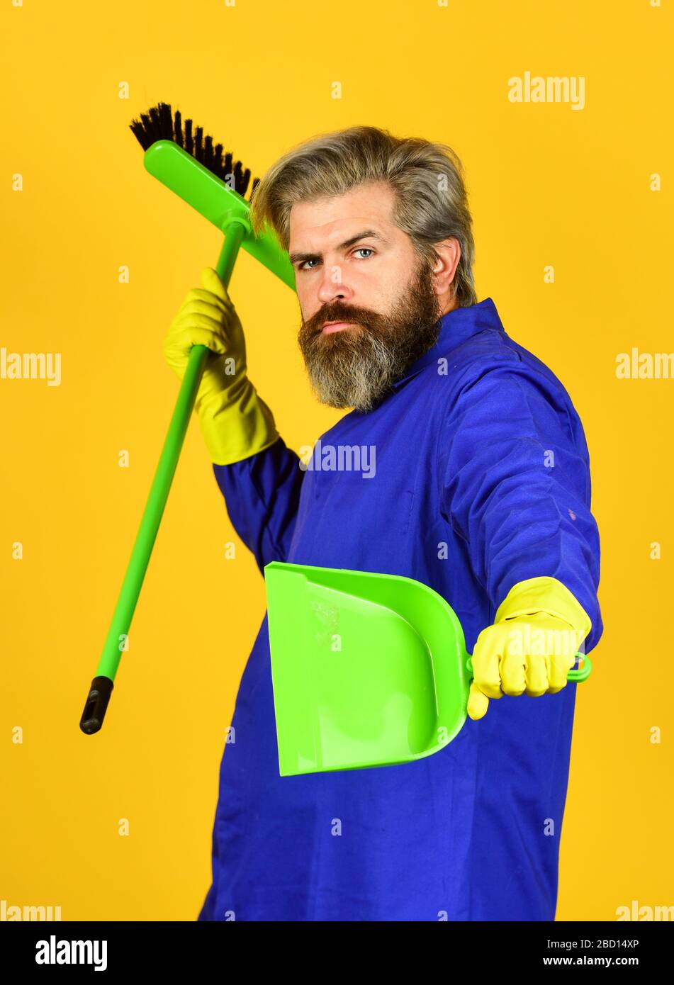 Janitor professional. Bearded hipster blue uniform with broom. Gardener ...