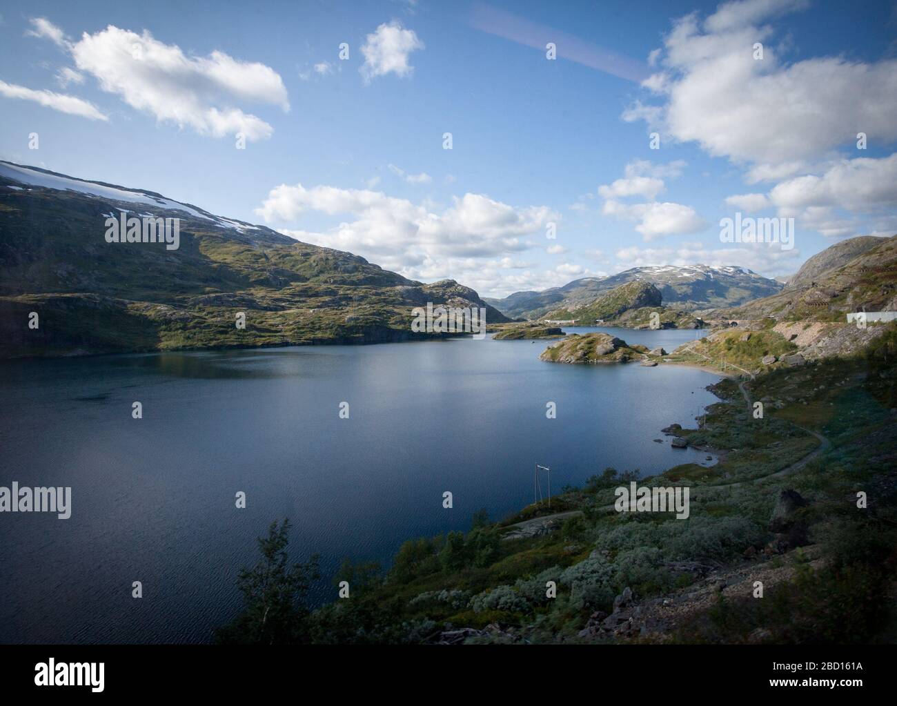 A small fjord is visible from the inside of a train that runs from Oslo ...