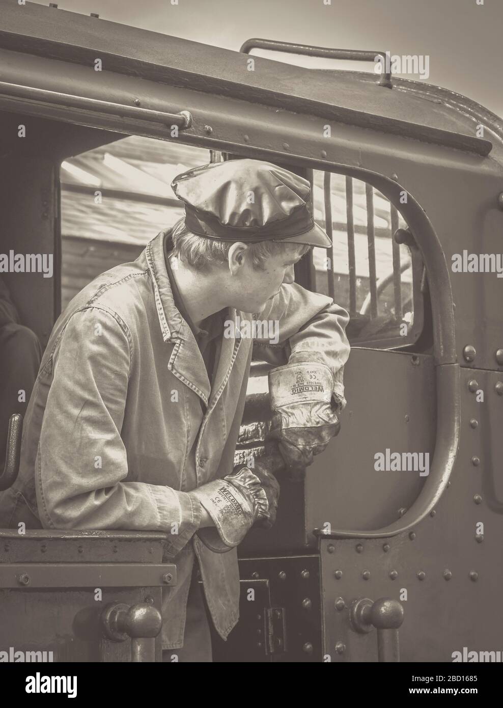 Black and white close up of steam train crew driver in vintage steam locomotive cab, Severn ...