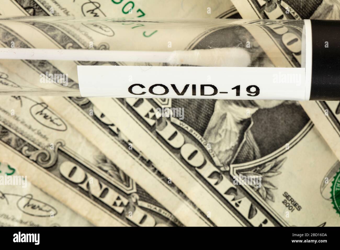 coronavirus tests lie on a one dollar bill, the symbolism of a pandemic ...