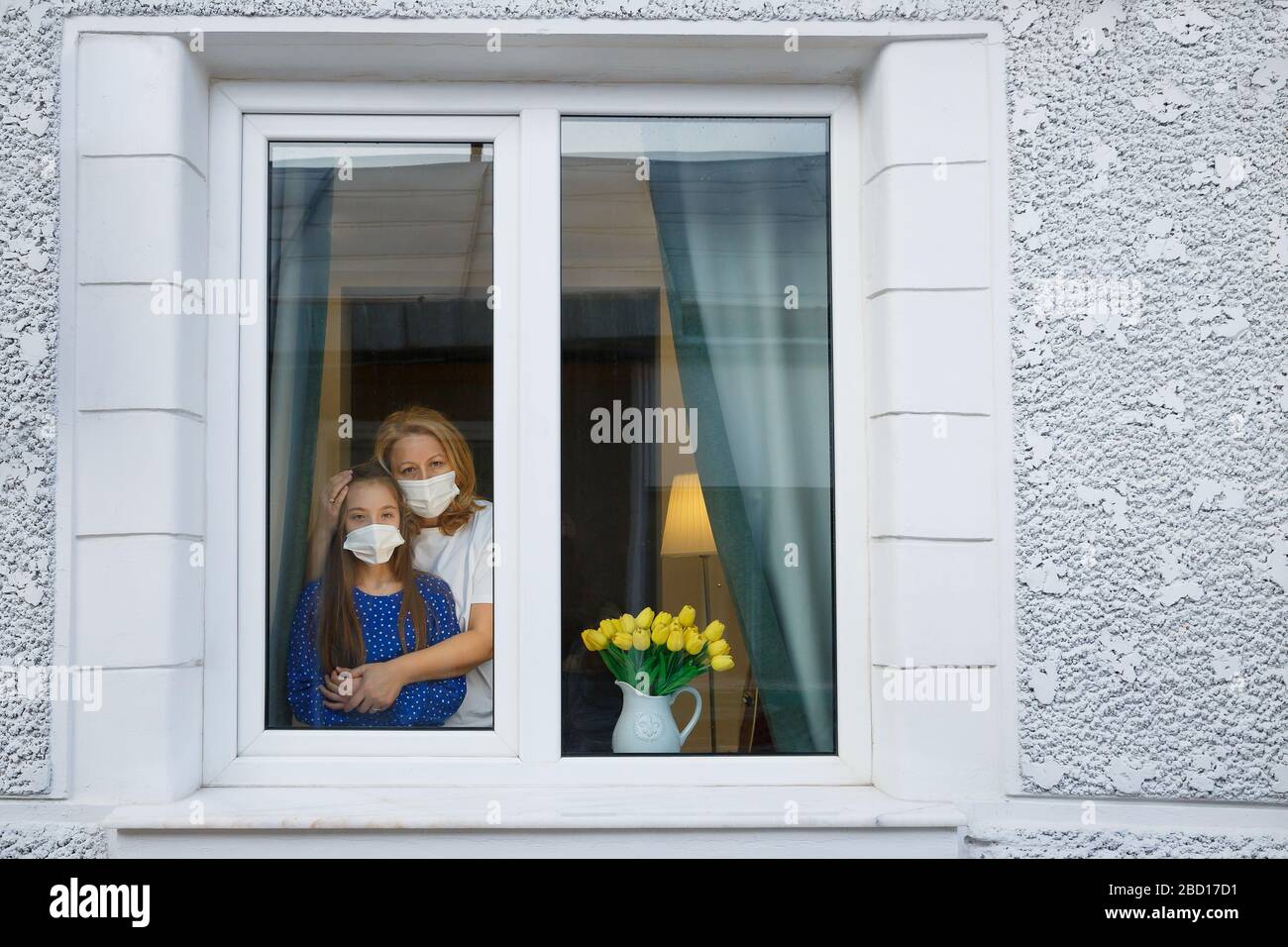 Quarantine window home for mother and daughter Stock Photo - Alamy