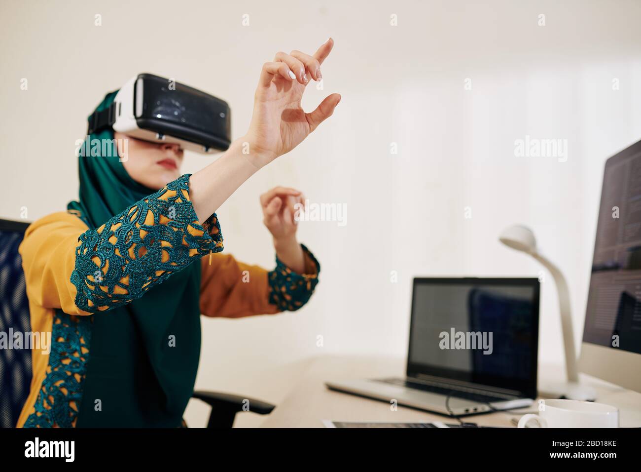 Muslim software developer testing new application she created for ...