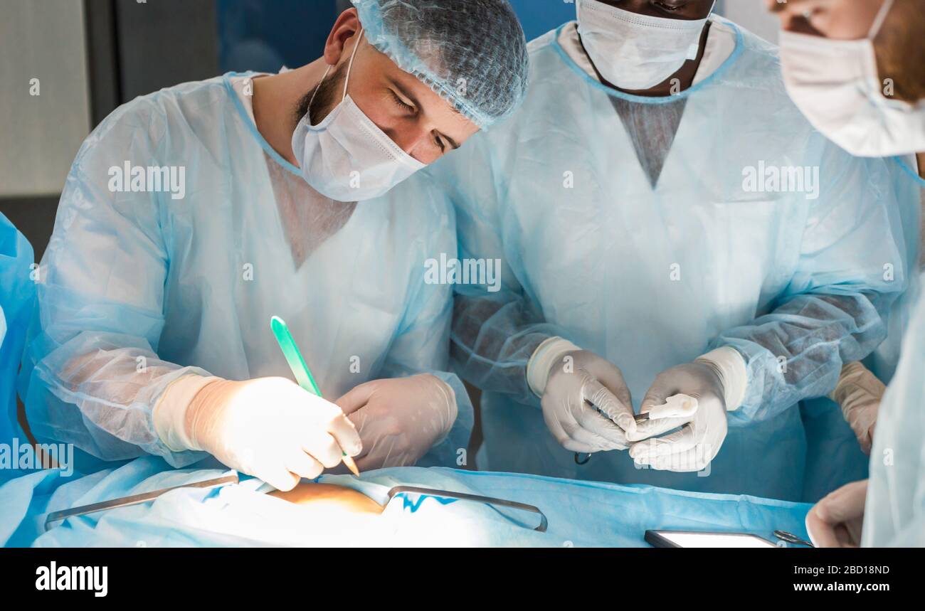 The senior surgeon in the operating room, where the patient is waiting ...
