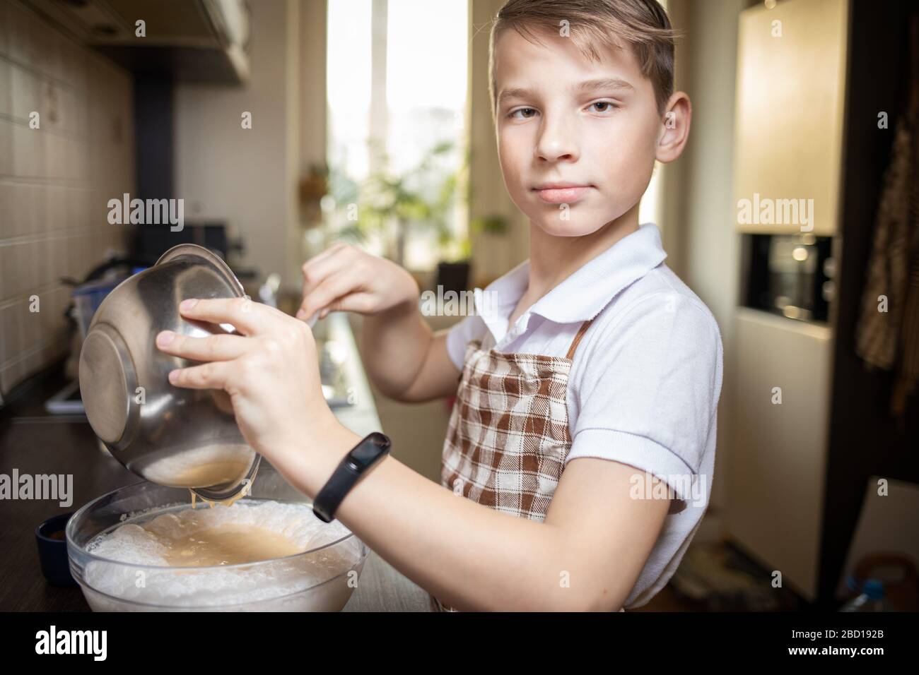 Small cute boy cooking dessert on the kitchen. Family cooking ...