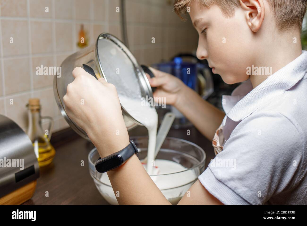 Small cute boy cooking dessert on the kitchen. Family cooking ...