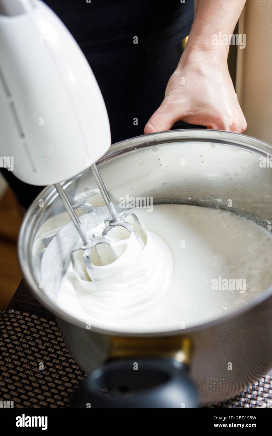 Woman whisking eggs whites mixer hi-res stock photography and images ...