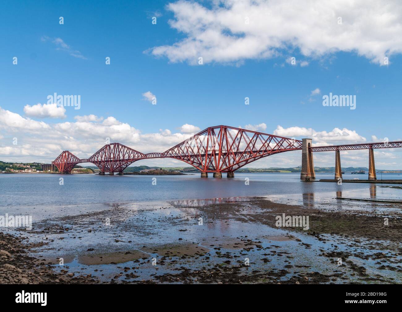 A view of the rail bridge over the river Forth with blue skys on a ...