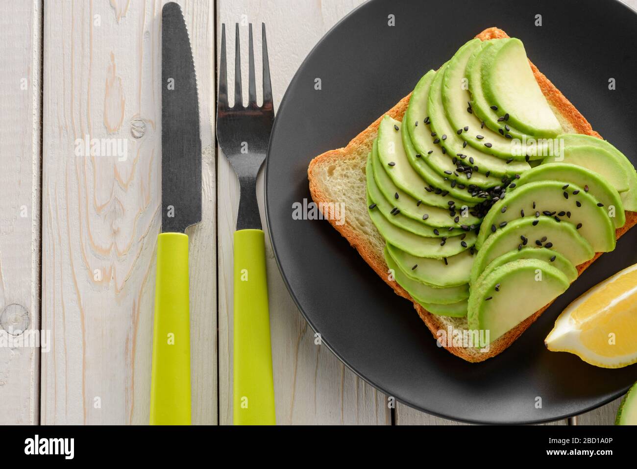 Avocado toast with sesame seeds and lemon Stock Photo - Alamy