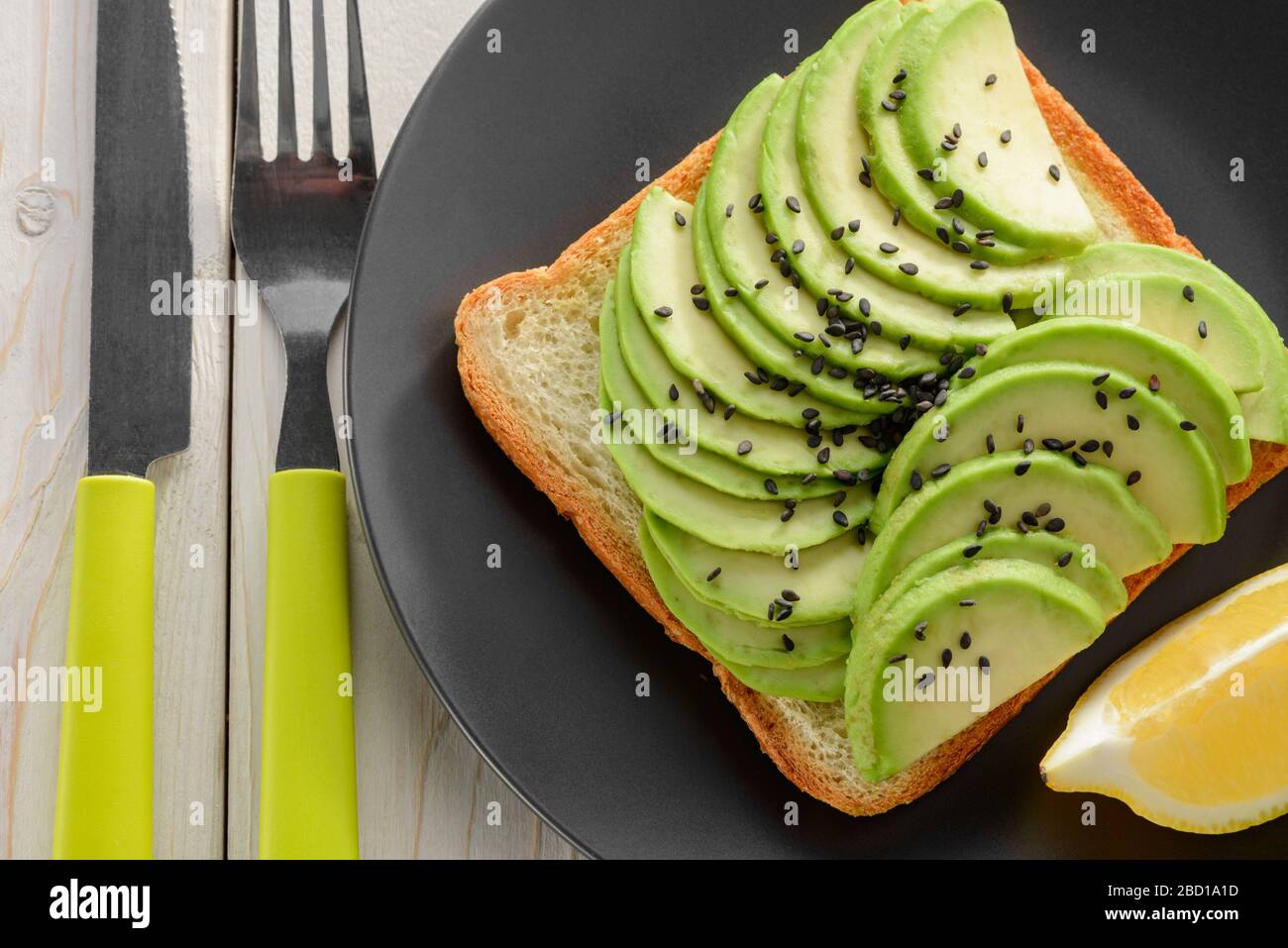 Avocado toast with sesame seeds and lemon Stock Photo - Alamy
