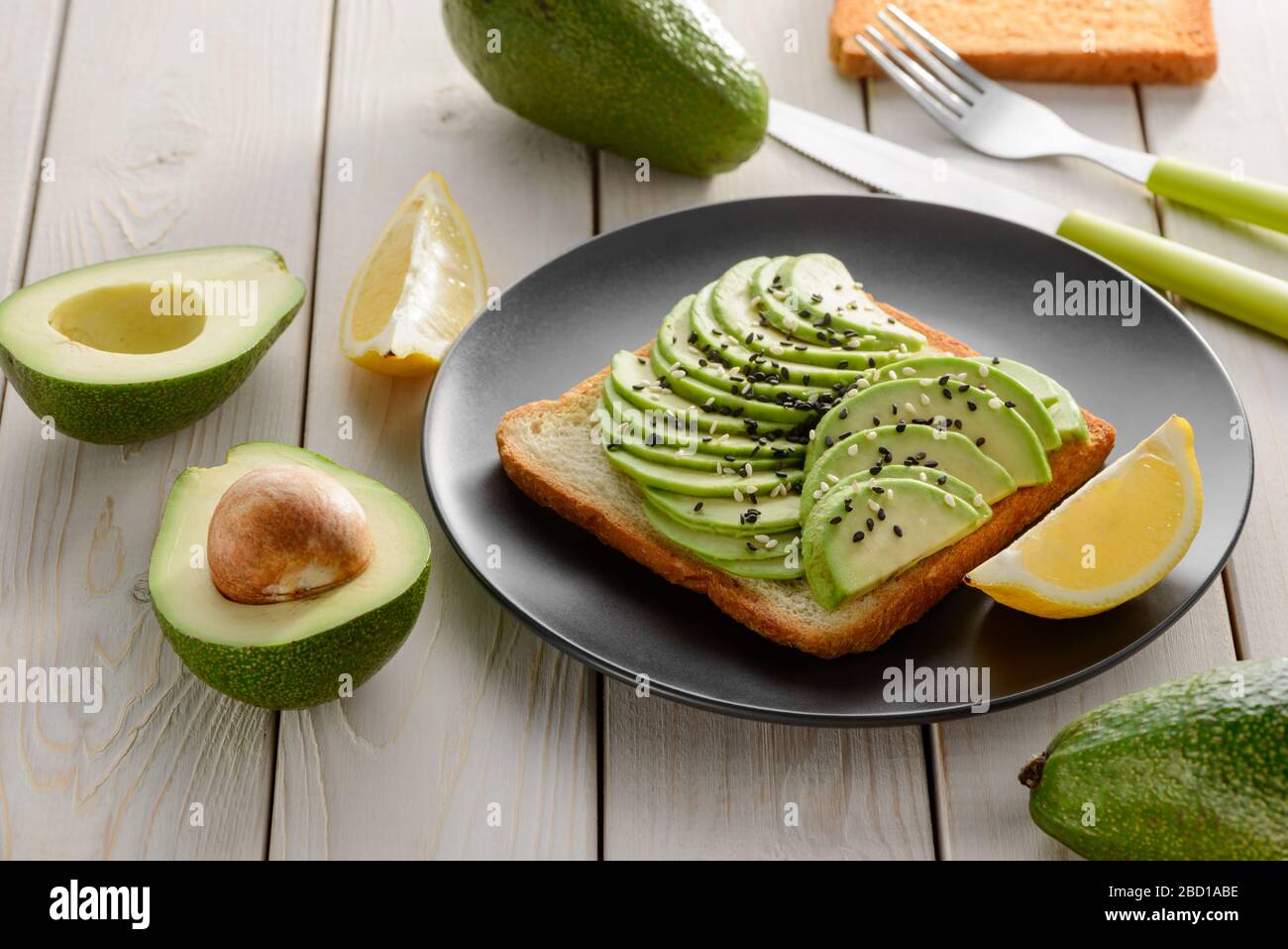 Avocado toast with sesame seeds and lemon Stock Photo - Alamy
