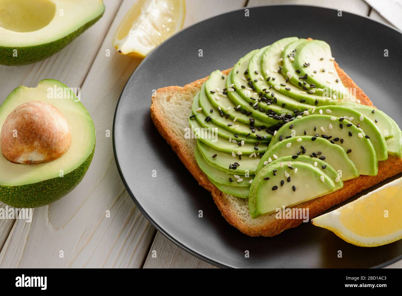 Avocado toast with sesame seeds and sprinkled lemon juice Stock Photo ...
