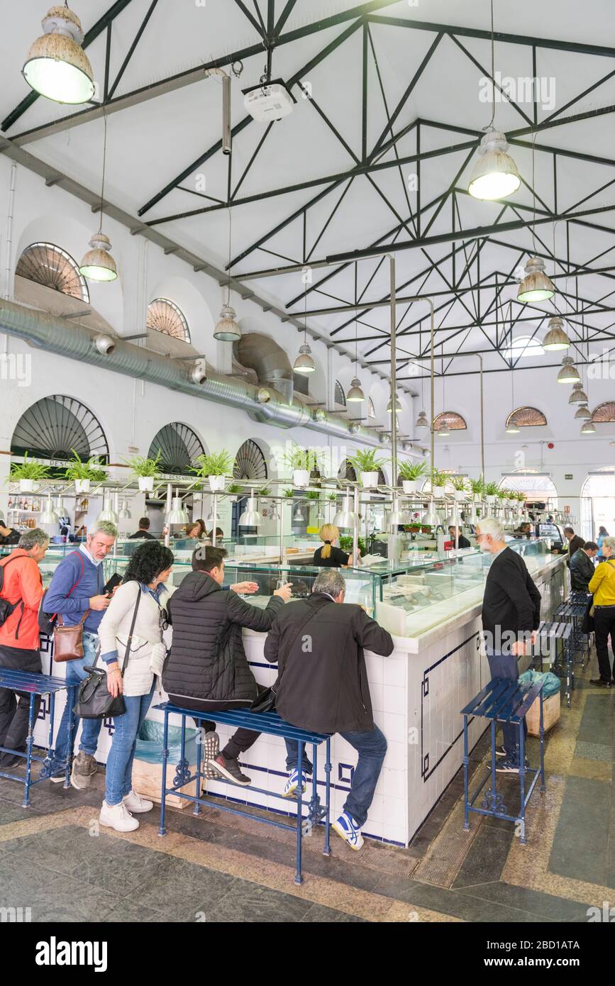 Customers earting at a restaurant at the Mercado de Triana, The indoor ...