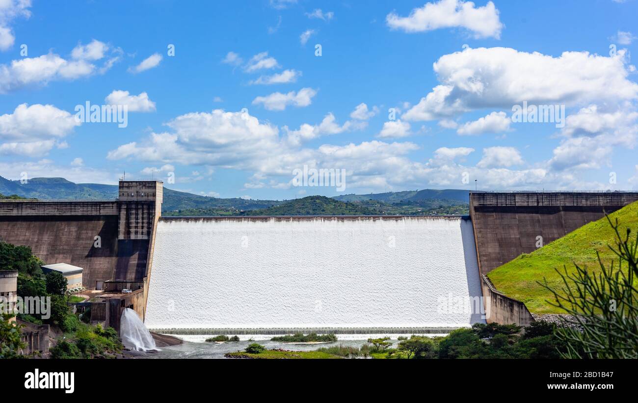 Dam wall structure summer rains full of river water overflowing weir ...