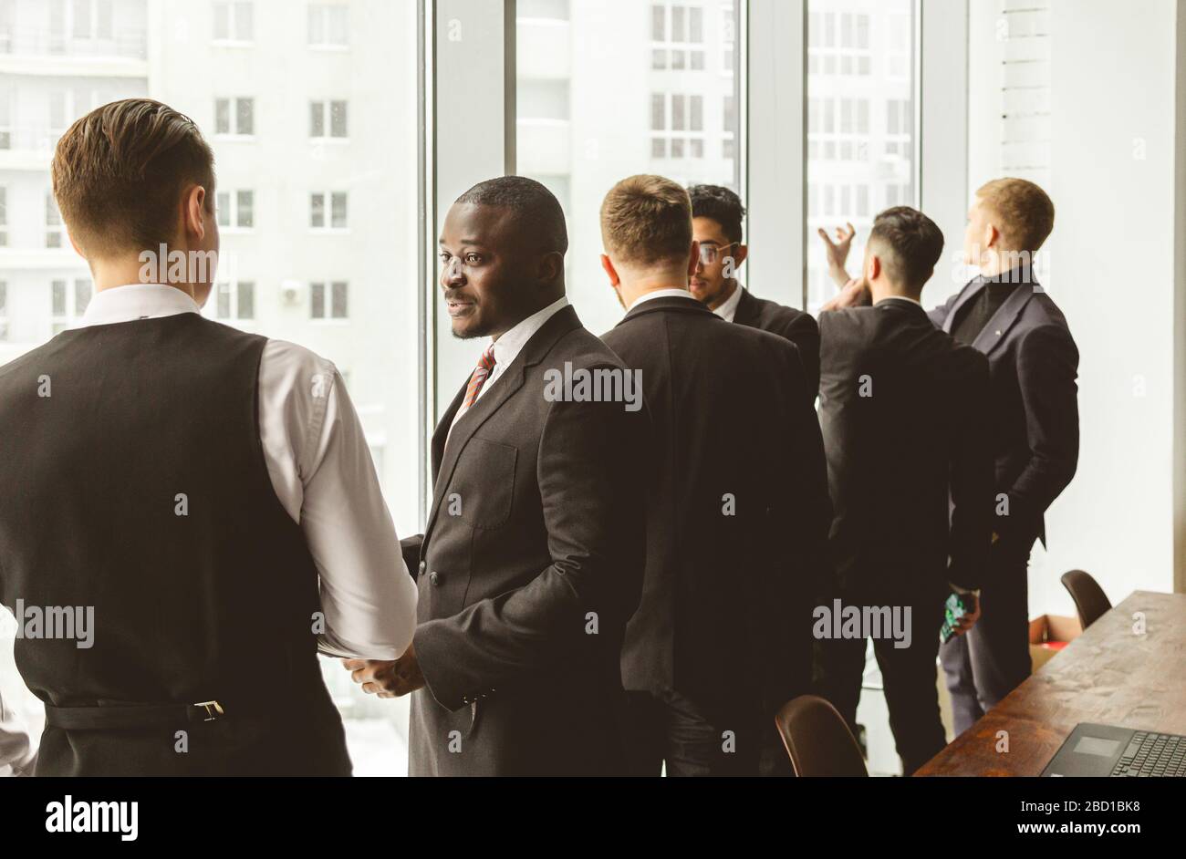 Dialogue of two businessmen in suits working and communicating together ...