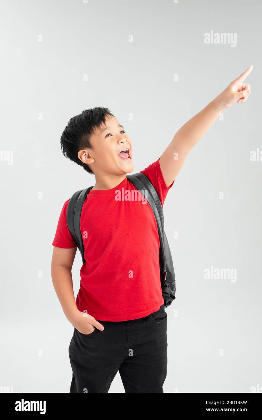 Smiling school boy with backpack pointing at you, isolated on white ...