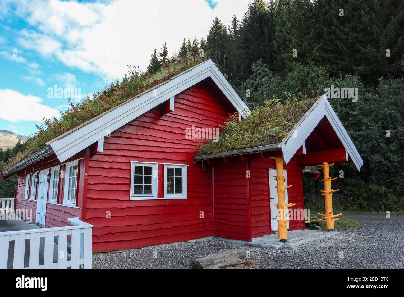 Red wooden traditional scandinavian green grass roof hut house in ...