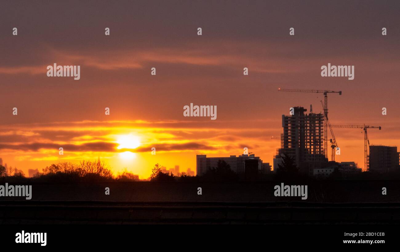 A fiery sun rises over the West London Skyline Stock Photo - Alamy