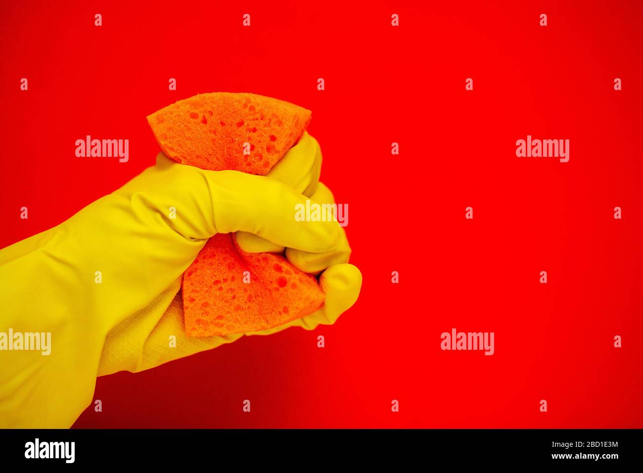 Closeup of hand in yellow mittens holding cleaning supplies Stock Photo ...