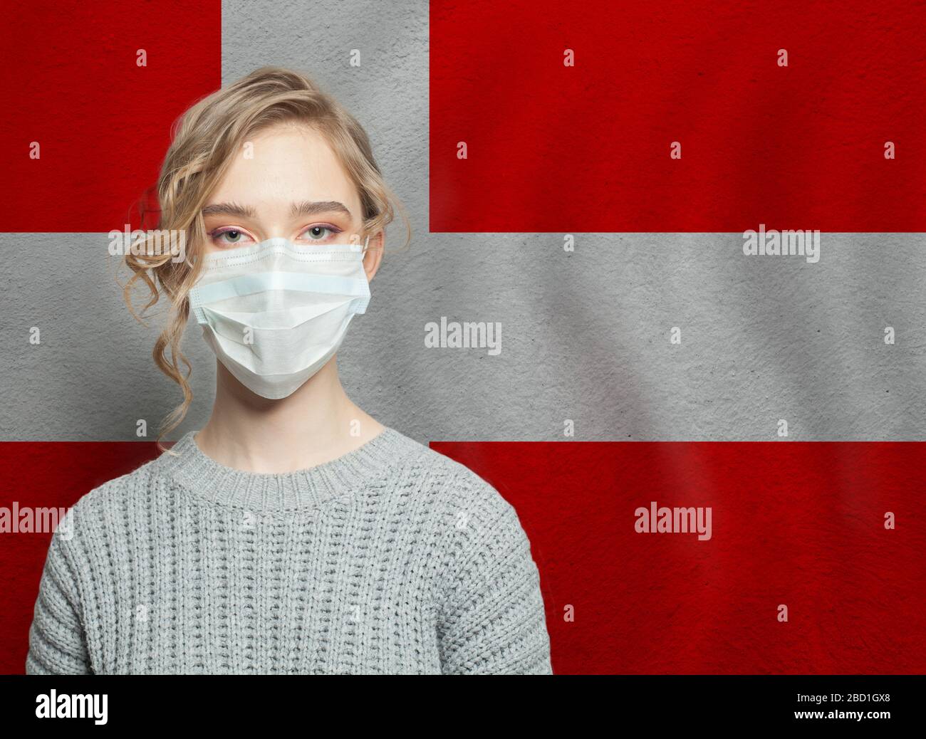 Young woman wearing a face mask with national flag Denmark. Flu ...
