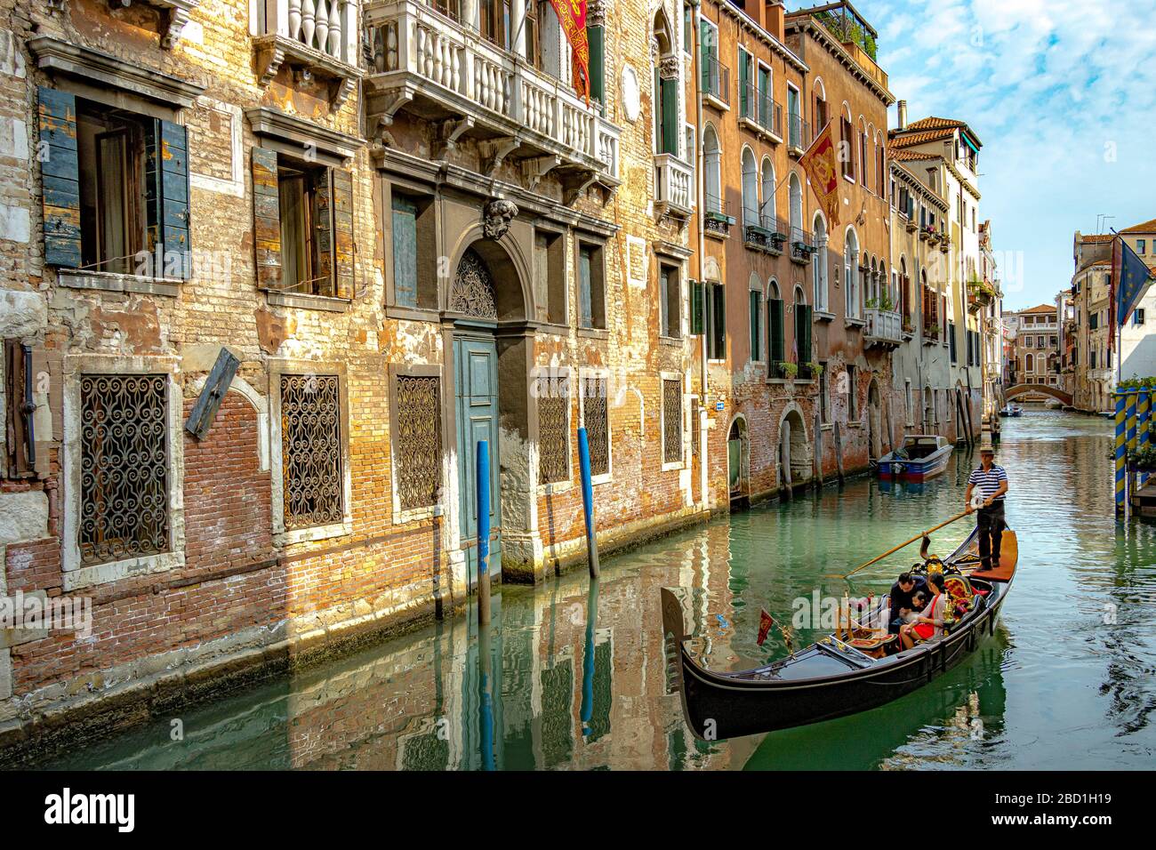 Tourists taking a gondola ride along rio de santa marina canal near ...