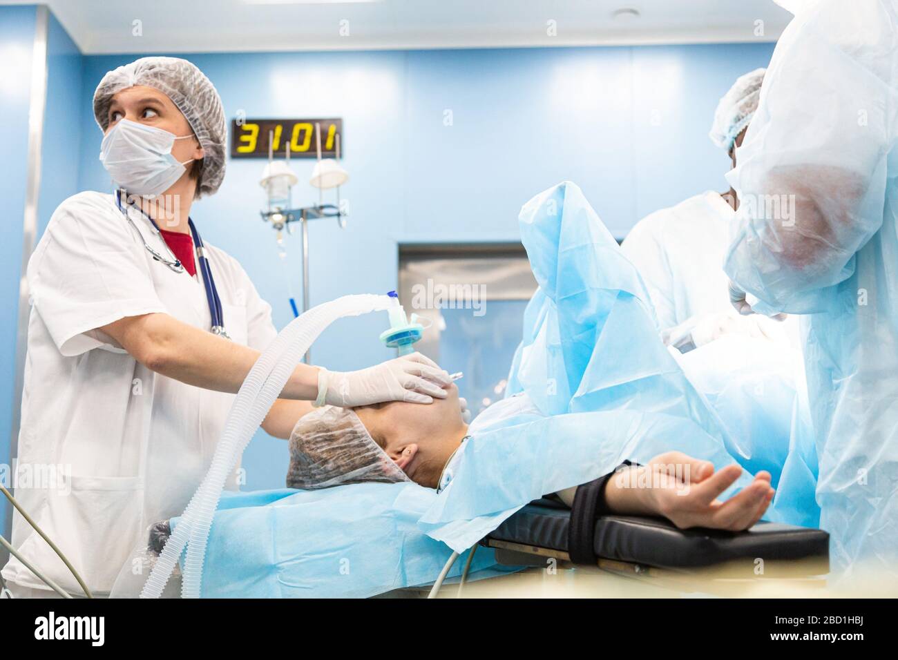 Portrait of an anesthesiologist among a team of doctors monitors ...