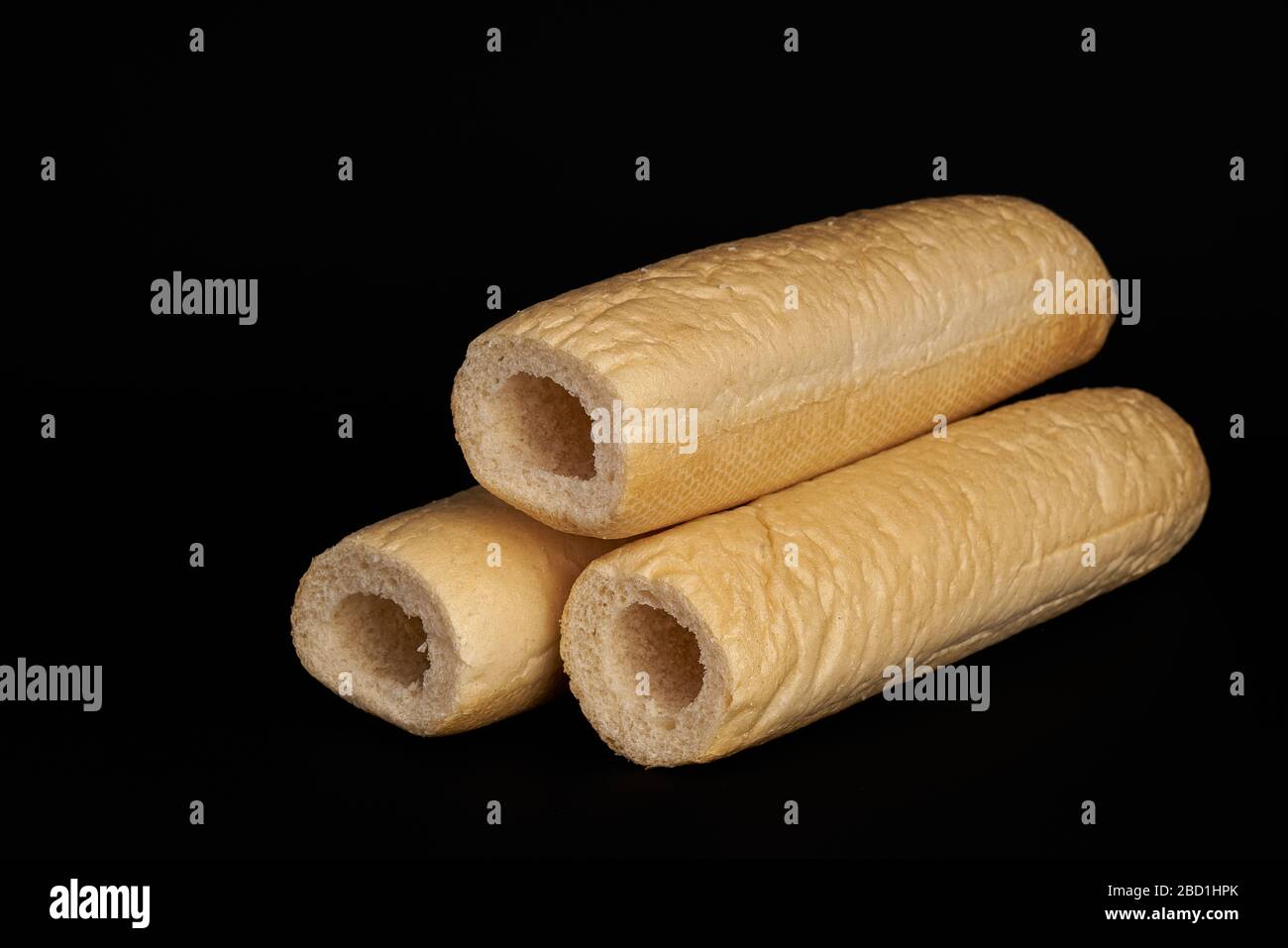 Three empty buns isolated on black background Stock Photo - Alamy