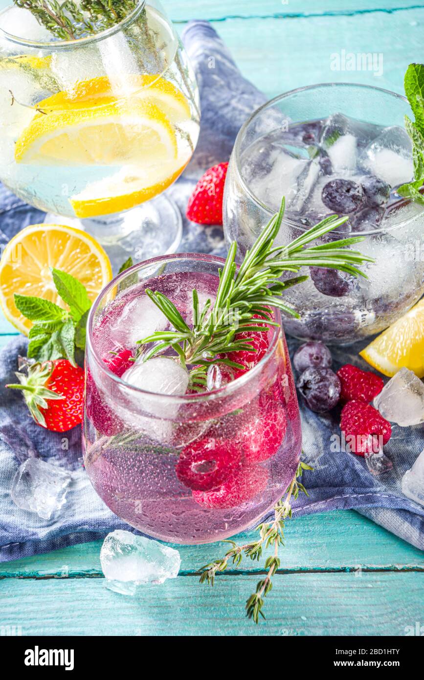 Summer cold drink concept. Fruit and berries gin tonic cocktail, or ...