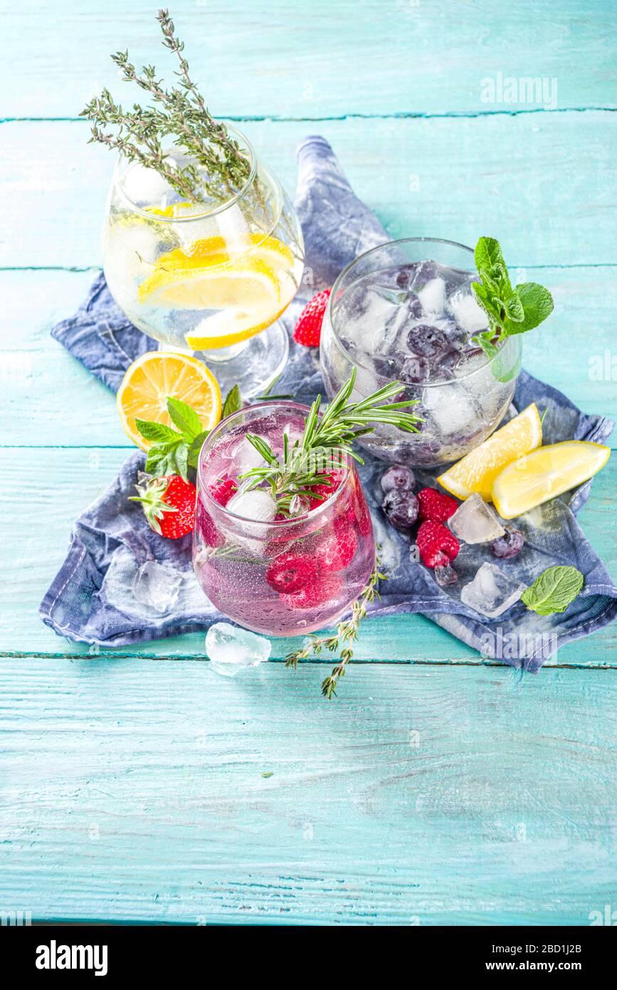 Summer cold drink concept. Fruit and berries gin tonic cocktail, or ...
