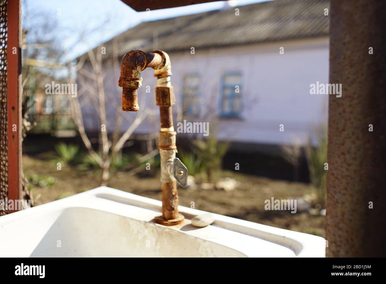 Old rusty water tap on a sink in a rural yard Stock Photo - Alamy