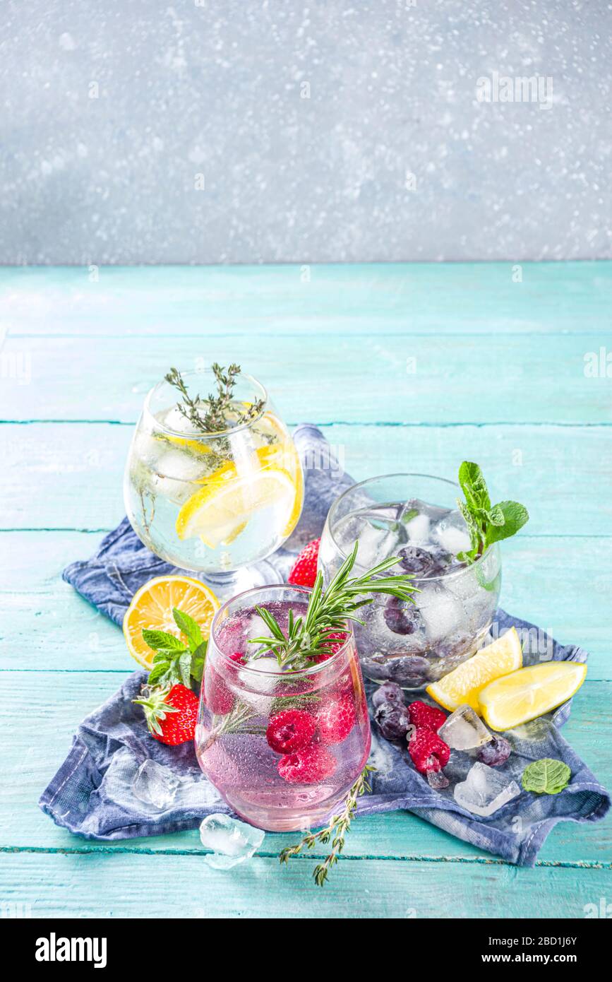 Summer cold drink concept. Fruit and berries gin tonic cocktail, or ...