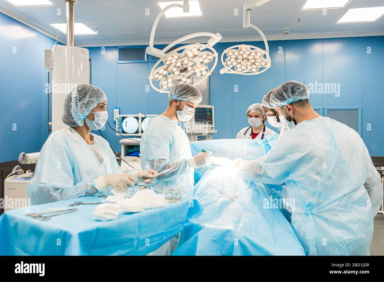 An international team of doctors performs a complex surgical operation ...