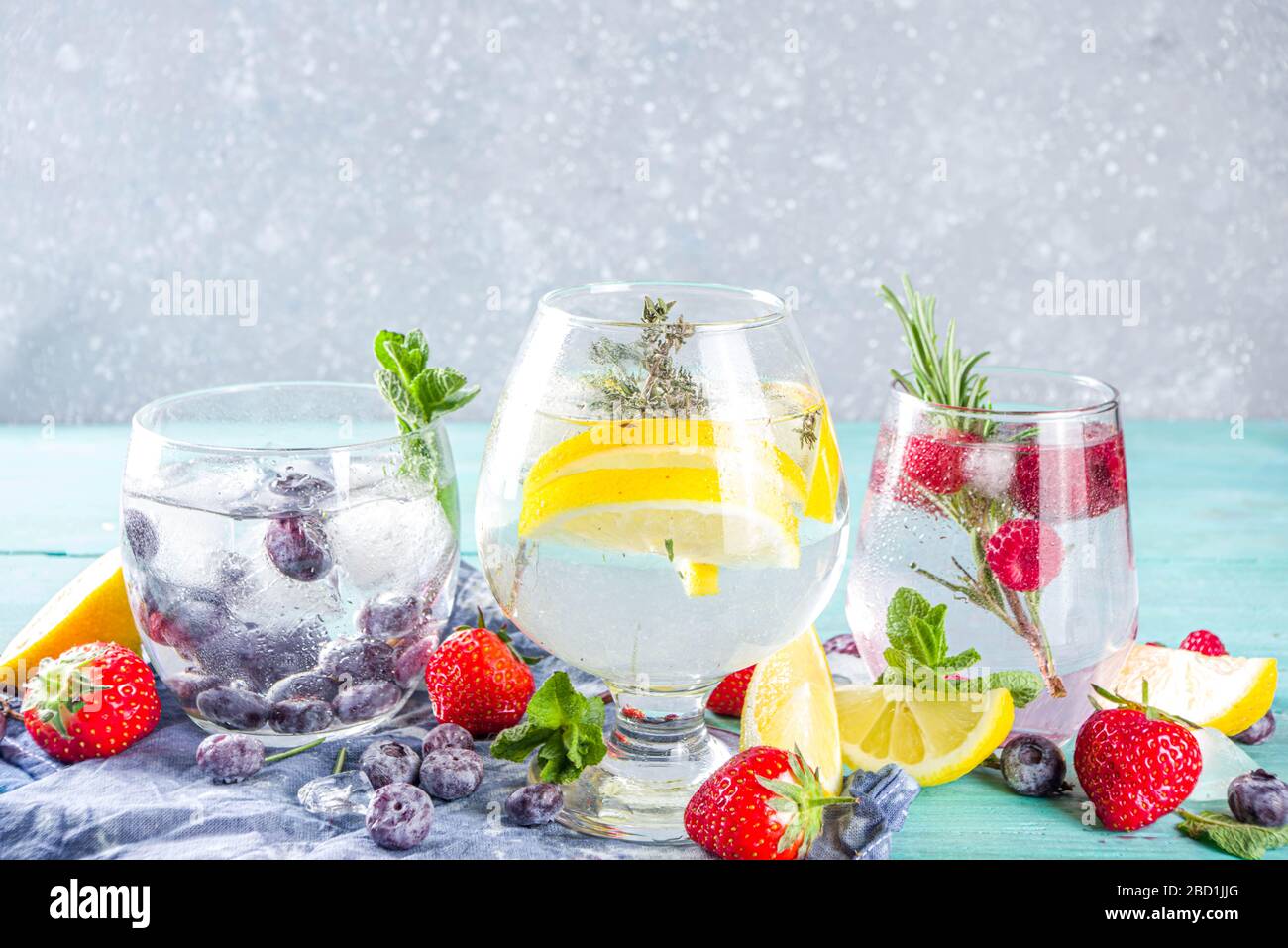 Summer cold drink concept. Fruit and berries gin tonic cocktail, or ...
