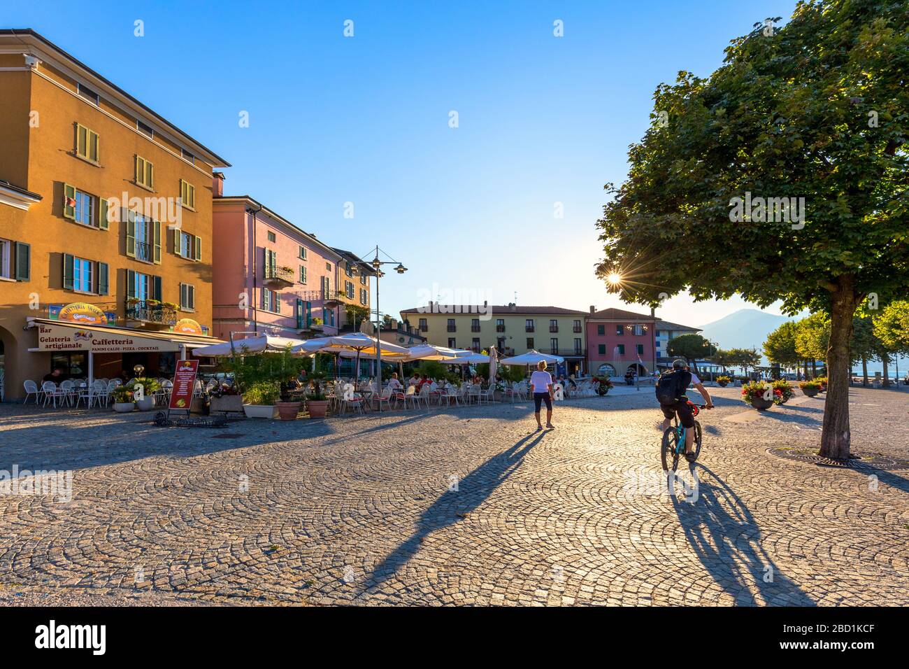 Colourful square of the village of Colico with passing tourists, Lake ...
