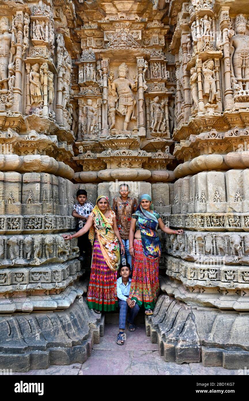 Family posing for photograph at the ornately carved Modhera Sun temple ...