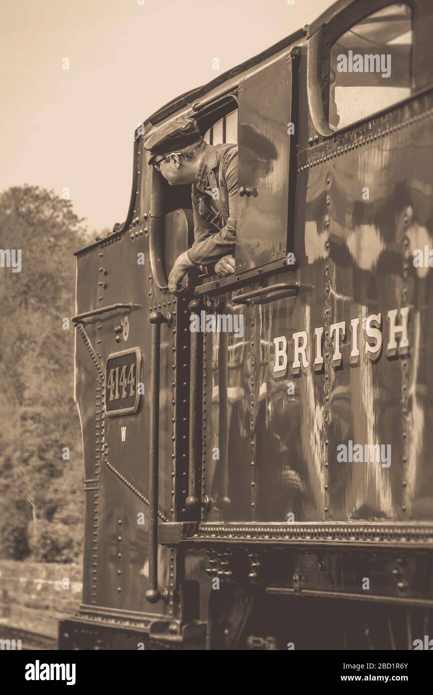 Old-fashioned sepia close up of steam train crew driver leaning ...