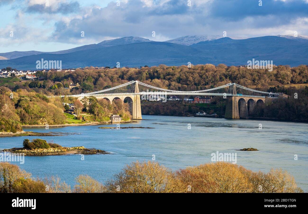 The Menai Suspension Bridge across the Menai Strait with the mountains ...