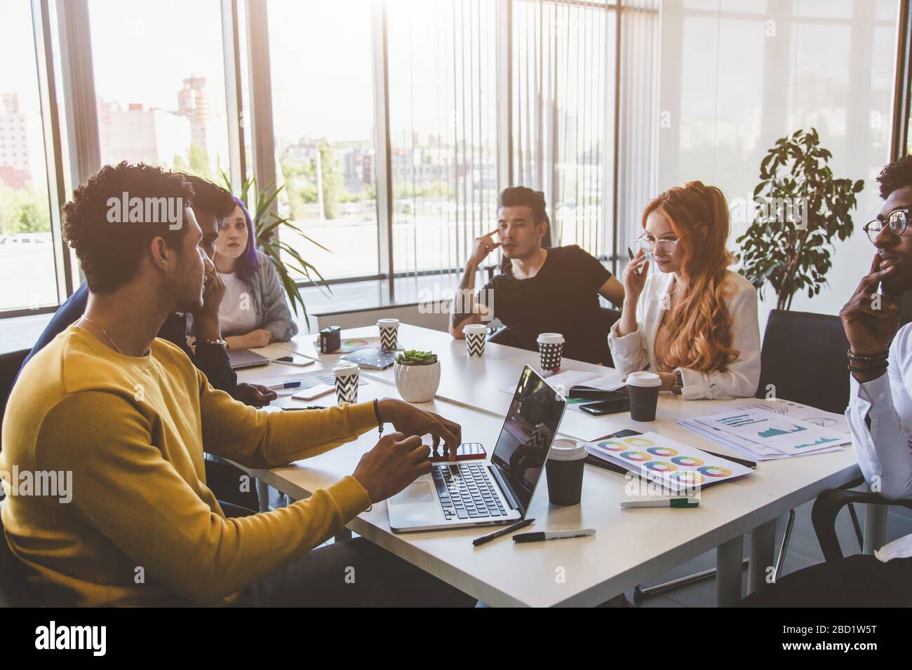 Executives sitting around conference table hi-res stock photography and ...