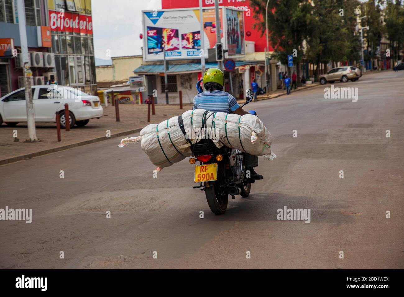 Kigali, Rwanda. 5th Apr, 2020. A man rides a motorcycle transporting ...