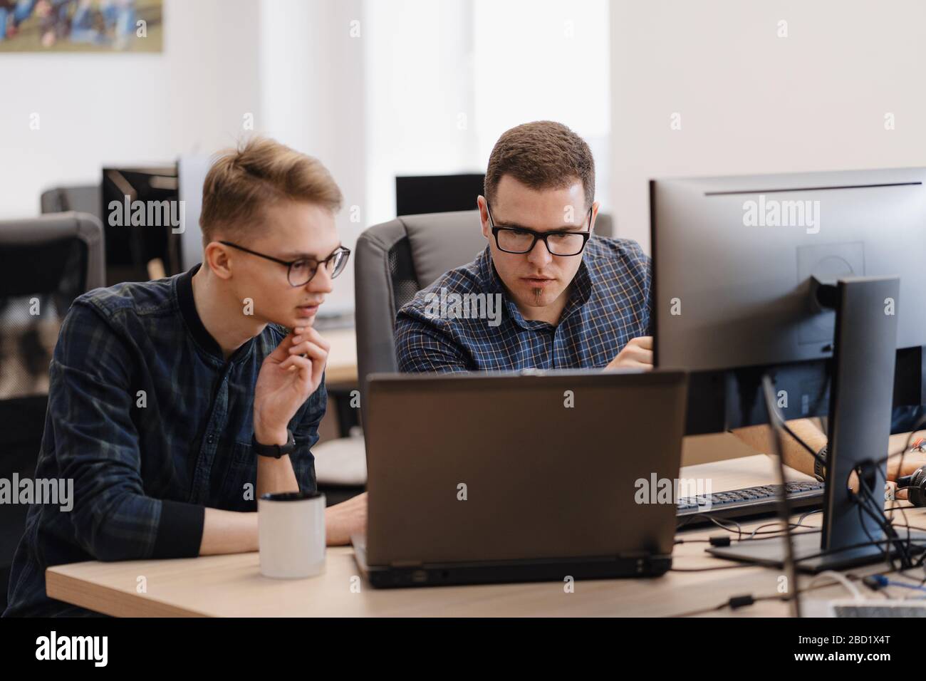 Full concentration at work. Group of young business people working and ...