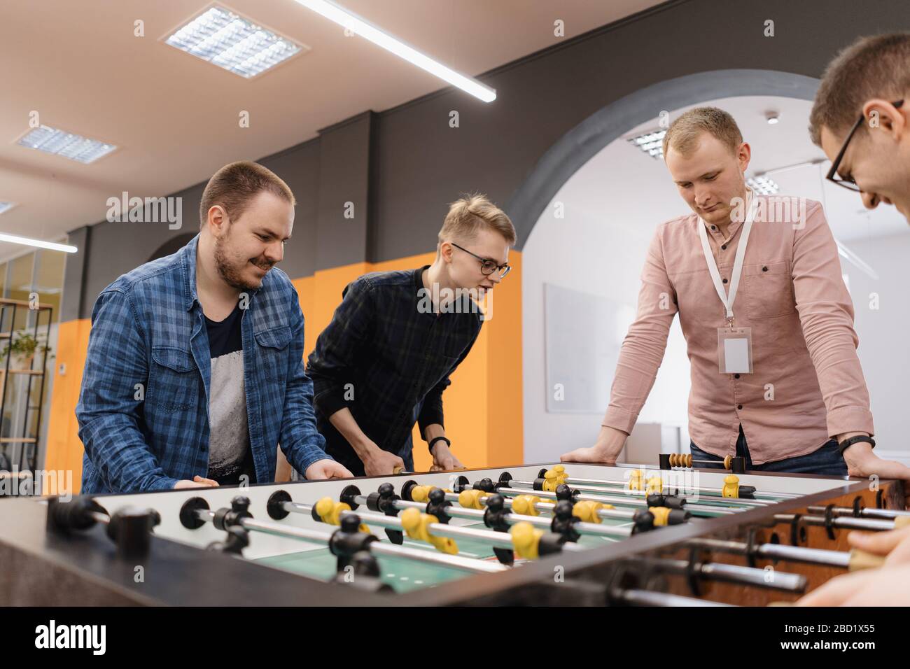 Group of Young Office Workers Playing Table Soccer Game Inside the ...