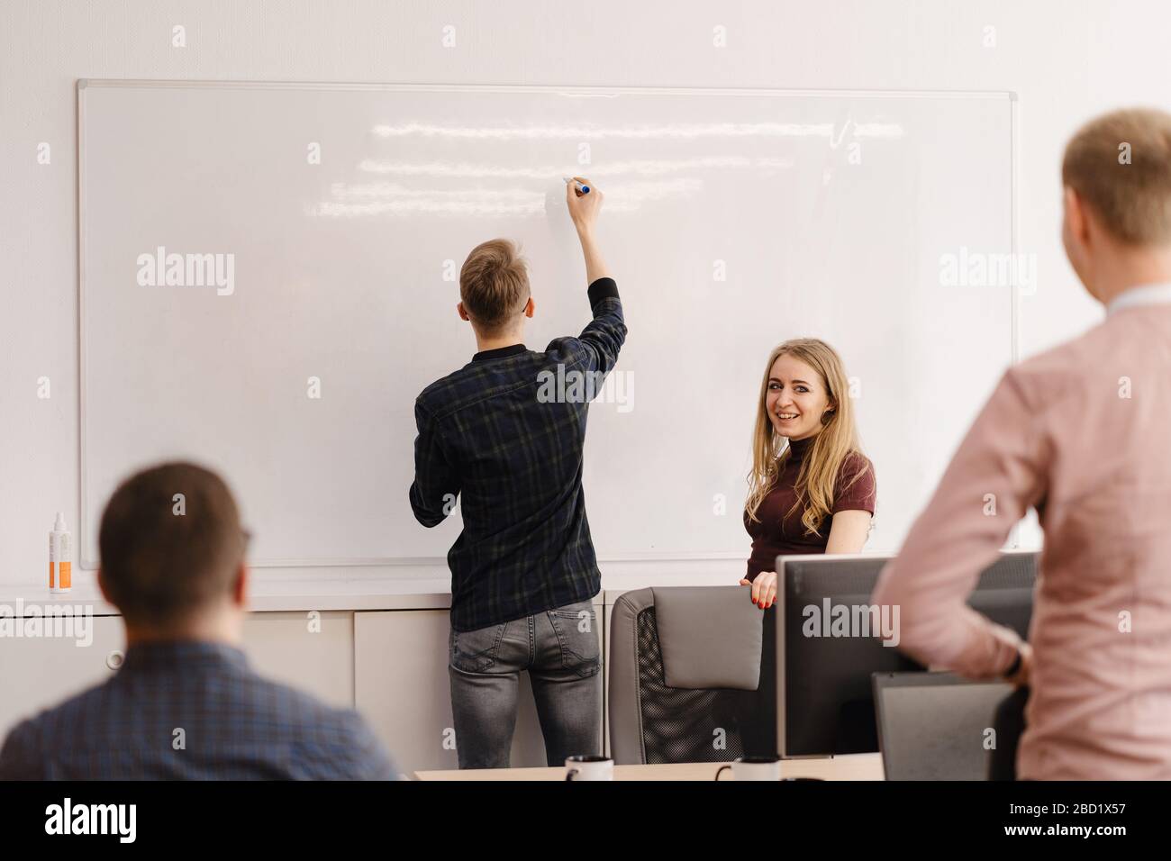 Shot of a male office worker giving presentation to his colleagues ...