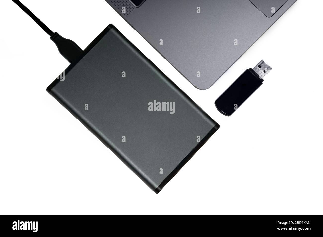 Portable hard disk connected to a laptop and a black flash drive ...
