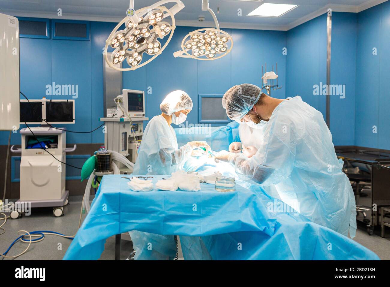 An international team of doctors performs a complex surgical operation ...