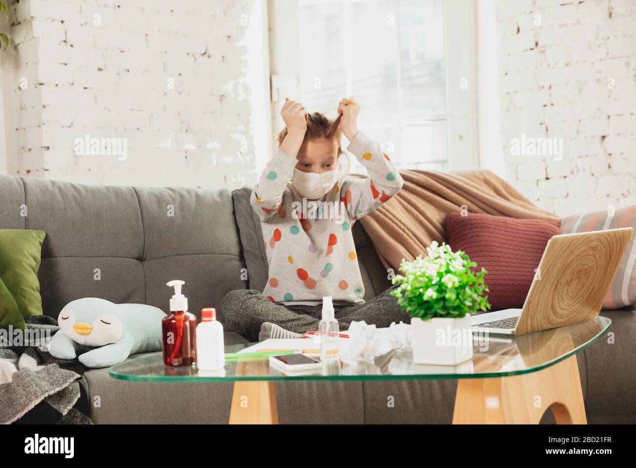 Little girl in protective mask isolated at home with coronavirus ...