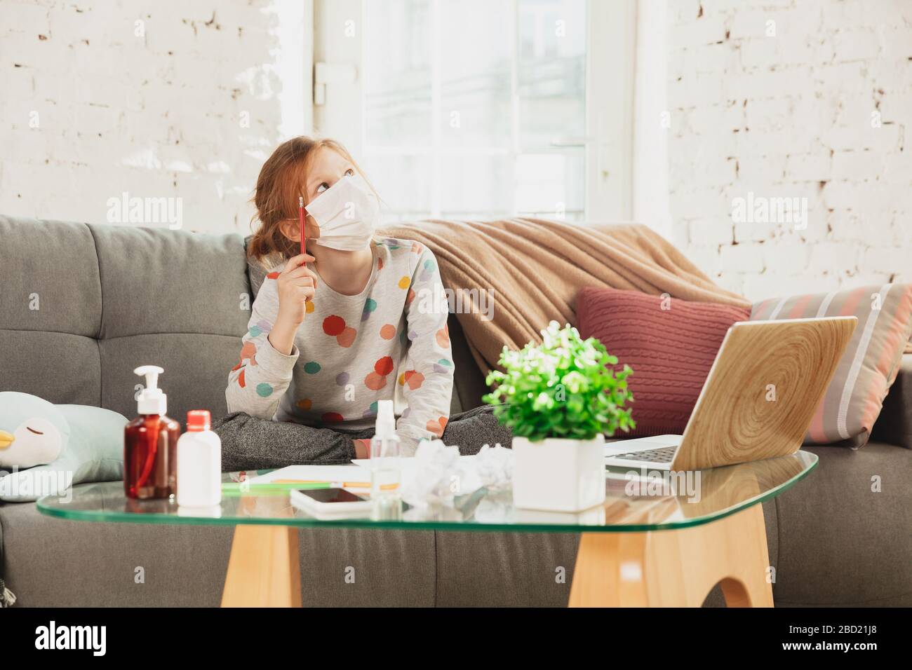 Little girl in protective mask isolated at home with coronavirus ...