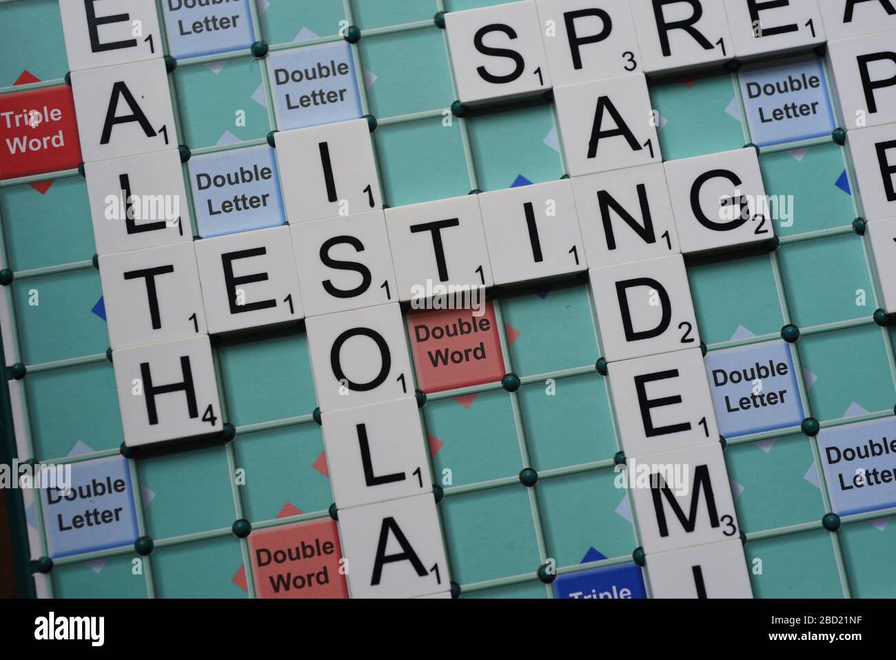 Coronavirus related words spelled out on a Scrabble board. Concept ...