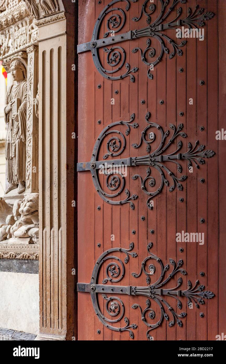 Ornate ironwork on door of the Church of St. Trophime, with statue of ...