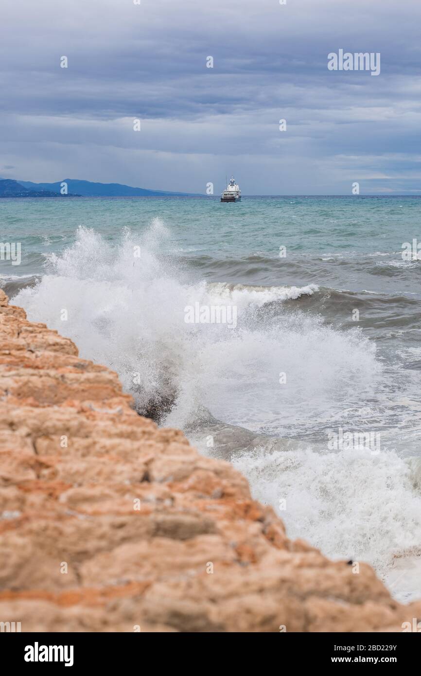 Wave hits the rock. Big waves in the sea. Ship in the sea Stock Photo ...