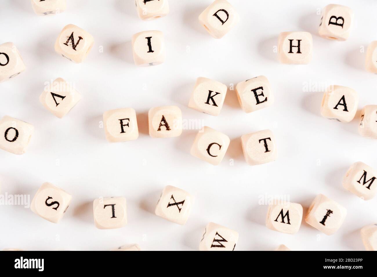 Fake or fact cubes with letters on a white background Stock Photo - Alamy